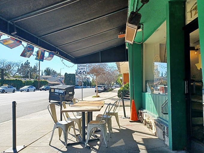 The sidewalk seating offers prime people-watching: half observing passersby, half watching their expressions as they smell what's cooking.