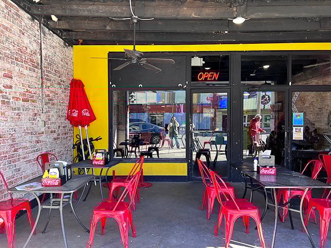 Outdoor seating with cheerful red umbrellas—because vitamin D makes everything taste better, especially Tom's legendary hot dogs.