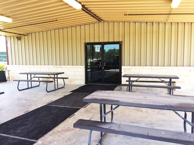 The covered outdoor seating area – where the aroma of post oak smoke mingles with Texas breeze, creating the perfect ambiance for serious eating.
