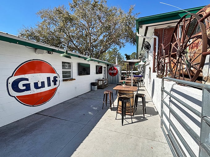 Outdoor seating with a side of nostalgia – that Gulf sign isn't just decoration, it's a reminder of road trips before GPS told us where to stop.