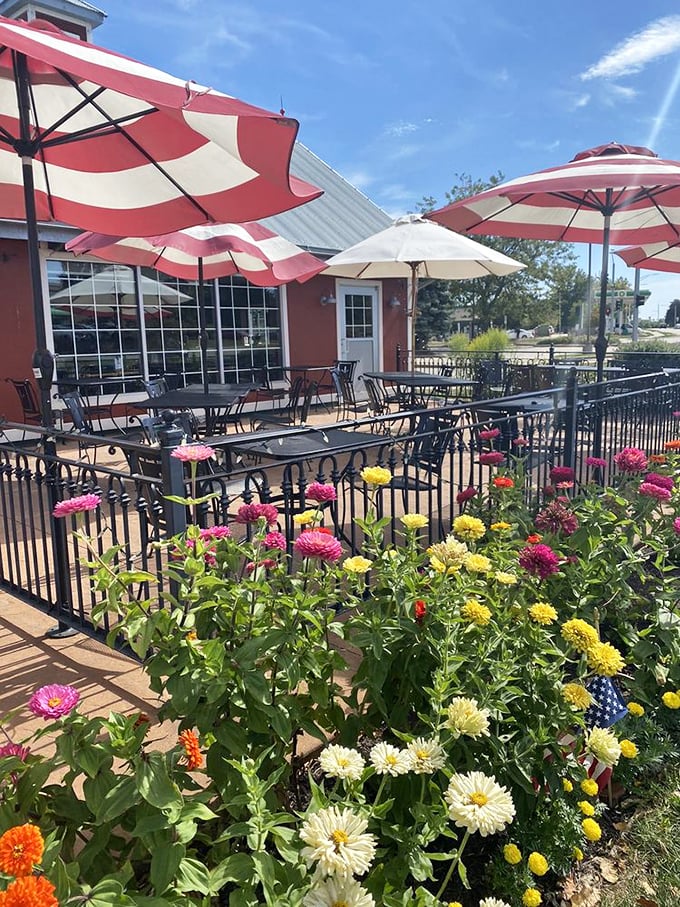 The patio blooms with both flowers and the promise of al fresco feasting under those cheerful red and white umbrellas.