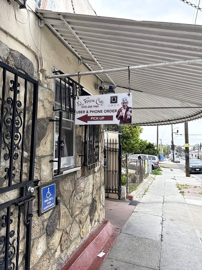 The side entrance offers a glimpse into the restaurant's practical evolution—modern convenience meeting decades-old tradition at the pickup window.