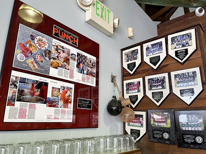 The wall of fame showcases press clippings and sports pennants—because great seafood deserves its trophies too.