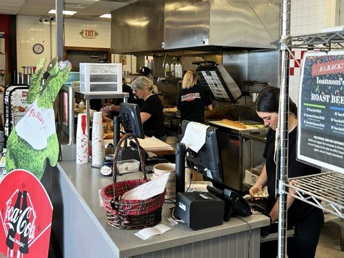 The kitchen ballet – where skilled hands transform simple ingredients into sandwiches worth crossing state lines for.