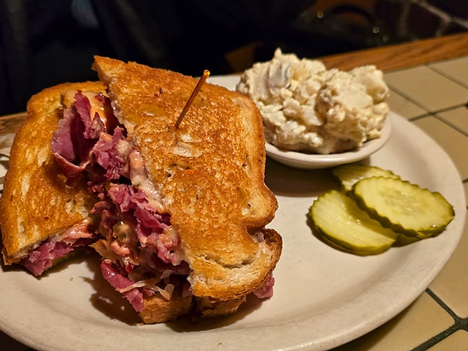 The Reuben sandwich—where corned beef, sauerkraut, and Swiss cheese perform a perfectly choreographed dance. Those pickle slices are the backup singers this sandwich deserves.