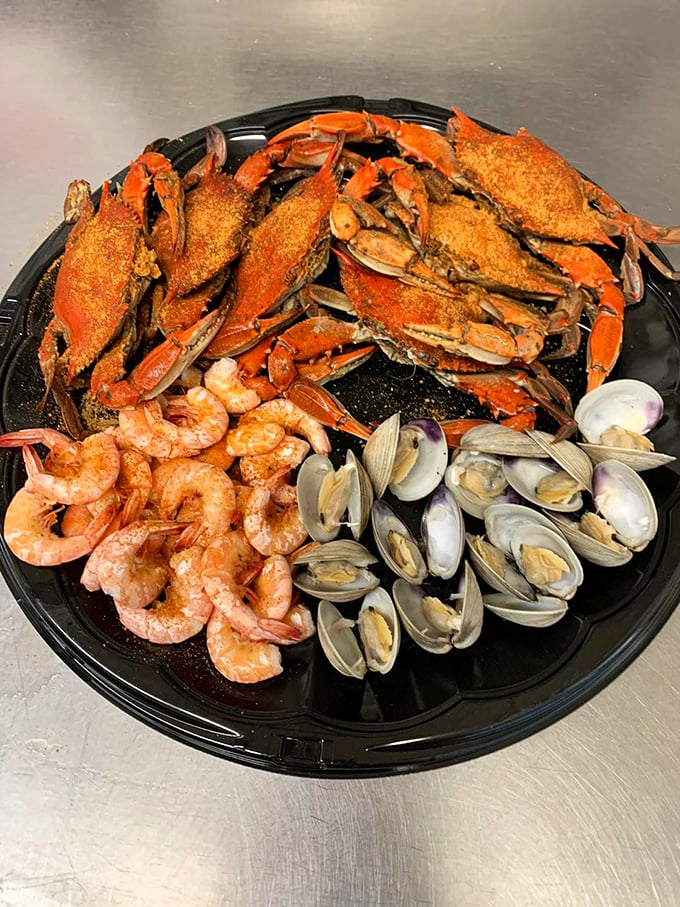 The seafood trifecta – crabs, shrimp, and clams sharing a plate like old friends at a reunion, each bringing their own special flavor.