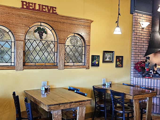 The "BELIEVE" sign says it all—this corner with stained glass windows feels like dining in a cozy sanctuary dedicated to good eating.
