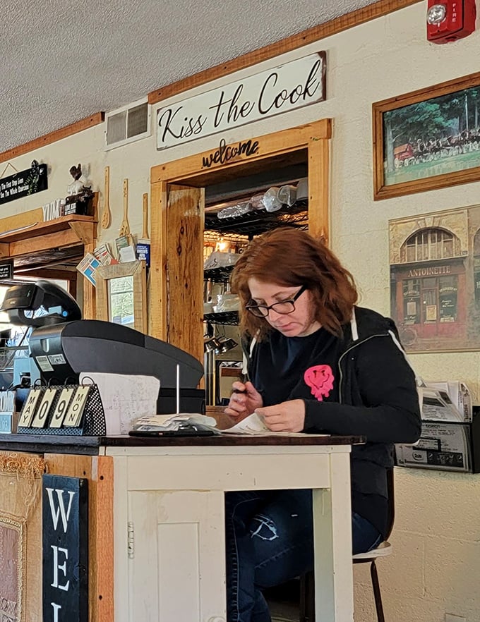 Behind every great restaurant is someone who makes the magic happen. The "Kiss the Cook" sign isn't just cute—it's solid advice.