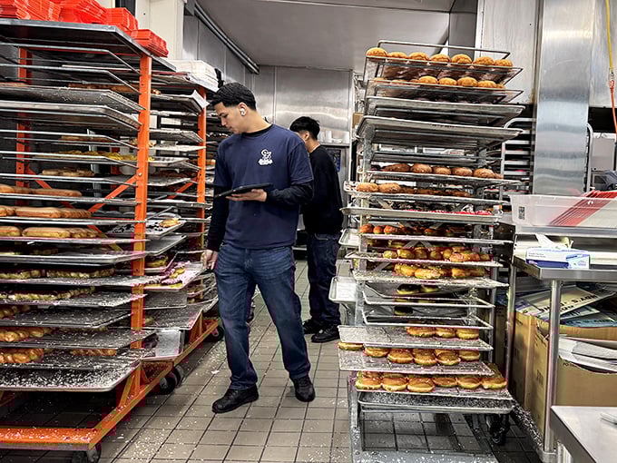 Behind the scenes, the magic happens with practiced precision. These aren't just employees—they're artisans of the donut craft.