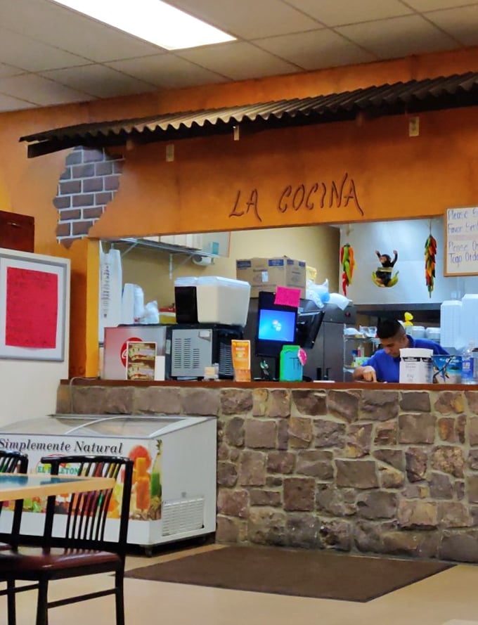 "La Cocina"—where the magic happens behind stone and corrugated metal, like a rustic food laboratory of deliciousness.