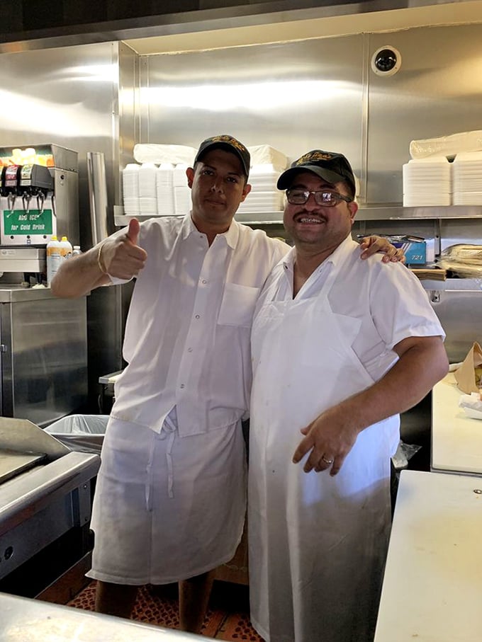 The wizards behind the curtain share a moment of camaraderie. In their white uniforms, they're the unsung heroes of countless happy meals.