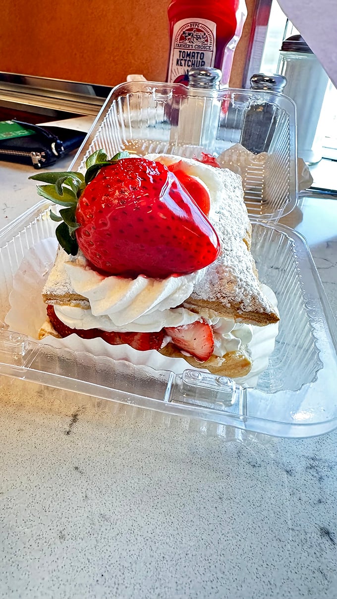 Dessert architecture at its finest—layers of cake, cream, and strawberries creating a sweet skyscraper that's worth every calorie.