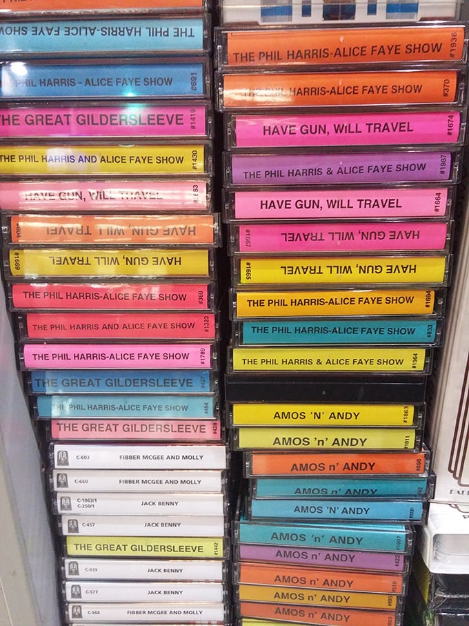 A rainbow of cassette tapes featuring classic radio shows—analog treasures in a digital world, each one a time capsule of entertainment history.