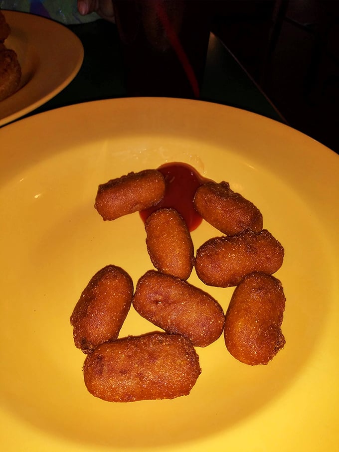 Golden-brown tater tots with a side of dipping sauce—proof that sometimes the simplest pleasures are the most satisfying.