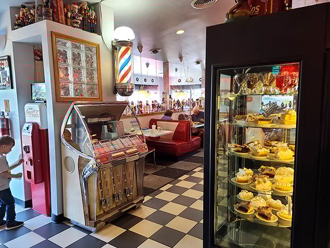 A dessert case that doesn't whisper temptation—it shouts it. And that vintage jukebox stands ready to provide the soundtrack to your sugar rush.