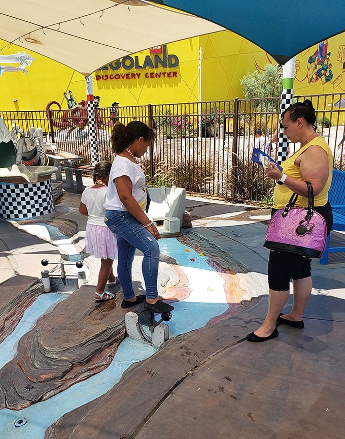 Families engage with interactive exhibits outside LEGOLAND, where children discover that some of the best toys don't require batteries or Wi-Fi connections.