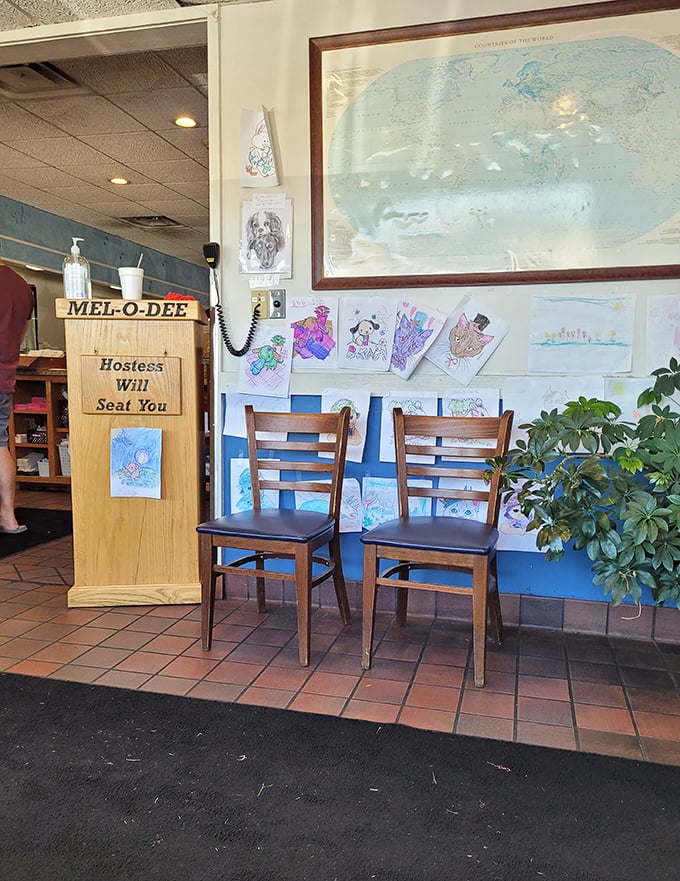 The waiting area wall – where children's artwork and world maps remind you that good food transcends boundaries.