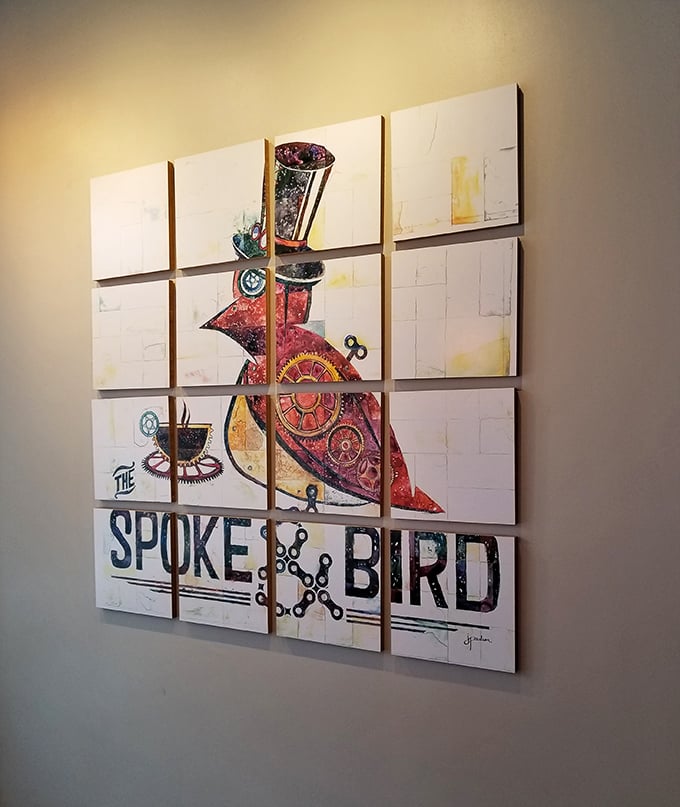Wall art that tells a story—the restaurant's steampunk-inspired bird mascot watches over diners like a dapper, mechanical guardian of good taste.