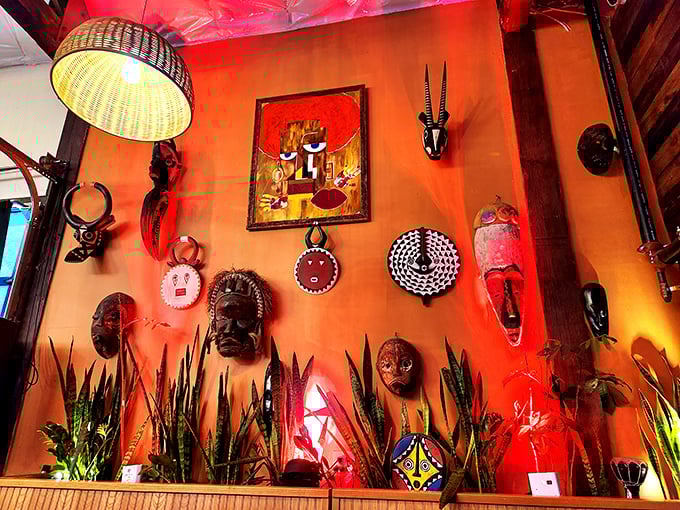 Traditional African masks and art transform a wall into a cultural gallery – dinner with a side of visual storytelling.