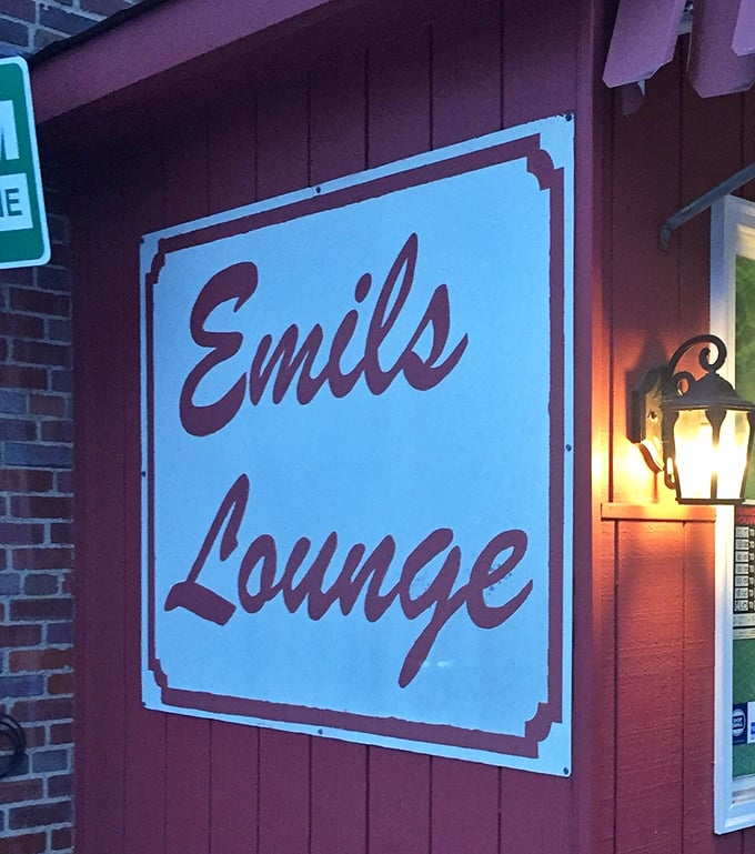 The sign promises "Lounge" but delivers "Institution"—Emil's name glows with the confidence of a place that knows exactly what it is.