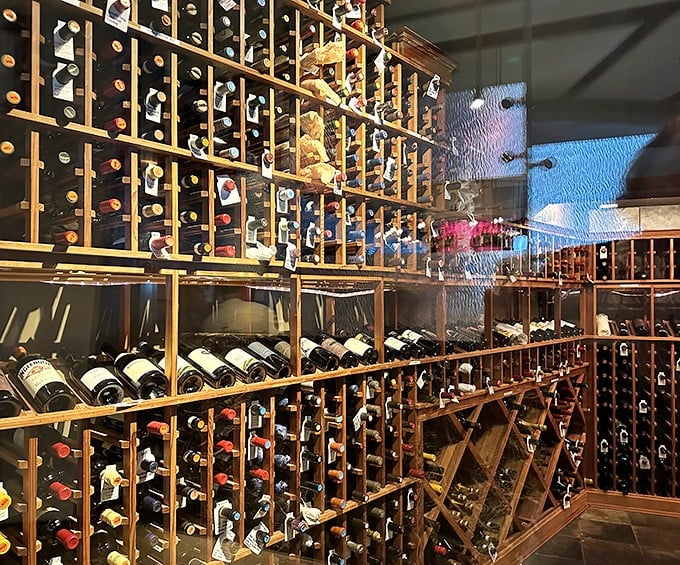 This wine cellar doesn't just store bottles—it houses liquid time capsules waiting to complement your seafood feast. Wooden racks cradle vintages like precious artifacts.