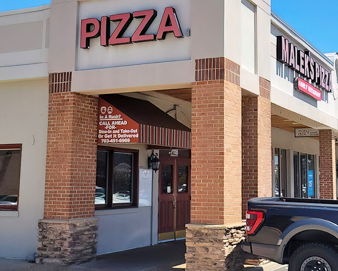 Malek's straightforward storefront with that bold "PIZZA" sign cuts right to the chase – no frills, just thrills for your taste buds.