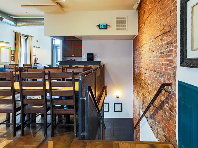 The second floor offers both elevation and perspective—wooden chairs waiting patiently for the next round of culinary conversations.
