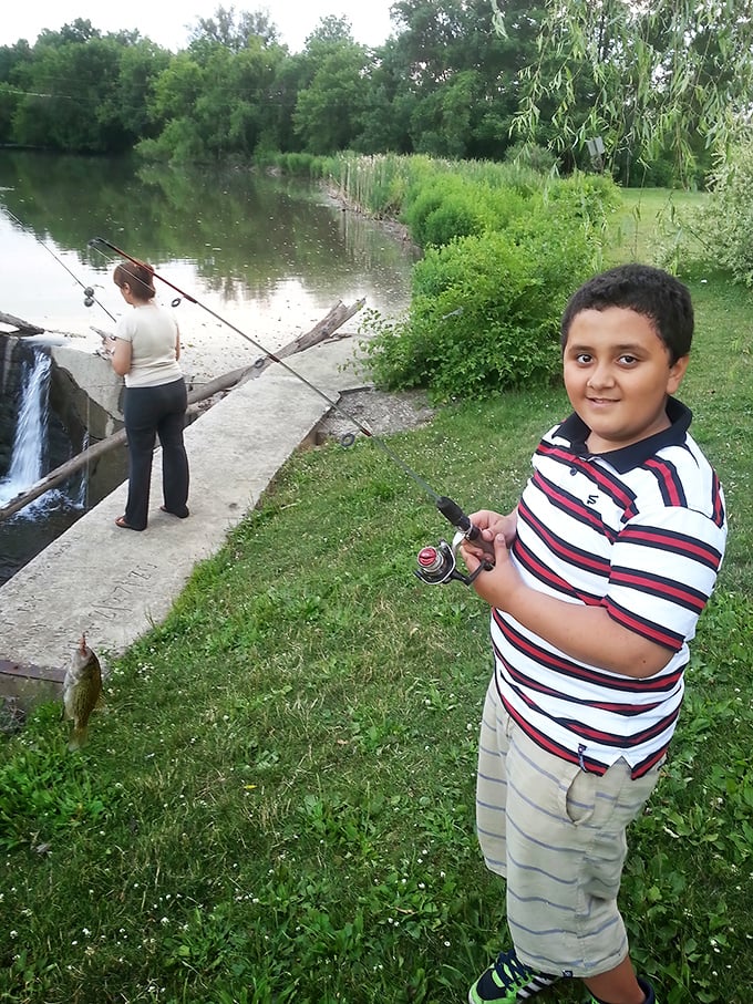Fishing at the park is a multigenerational affair. That proud smile says, "First catch of the day!" louder than words ever could.