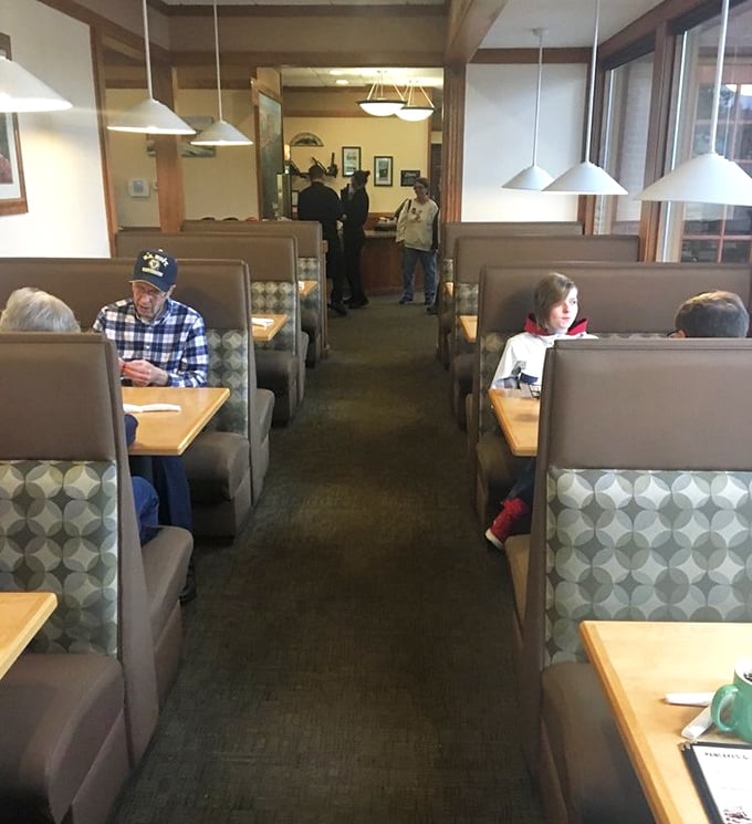 Cozy booth seating creates intimate dining islands where conversations and coffee flow freely—the quintessential American diner experience.