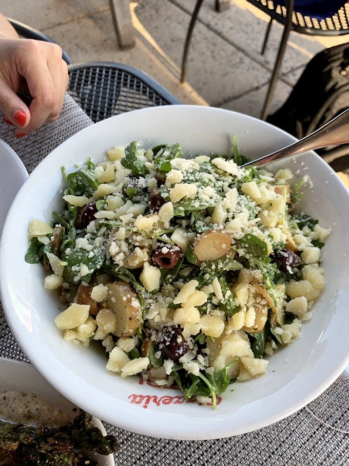 A bowl of greens that doesn't feel like punishment. This arugula salad proves vegetables can party too, especially with good cheese involved.