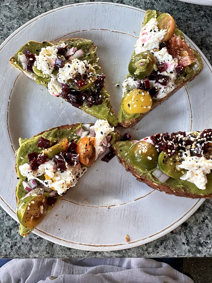 Avocado toast that's elevated from basic breakfast to edible art—proof that sometimes food trends stick around because they're actually delicious.