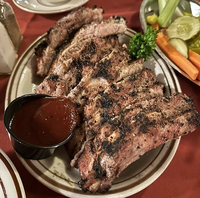 These ribs aren't just falling off the bone—they're practically jumping onto your fork, begging to be devoured alongside that house barbecue sauce.
