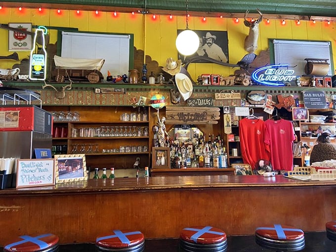 The bar doesn't just serve drinks—it serves history, with every bottle, sign, and cowboy hat telling stories of Fort Worth's colorful past.