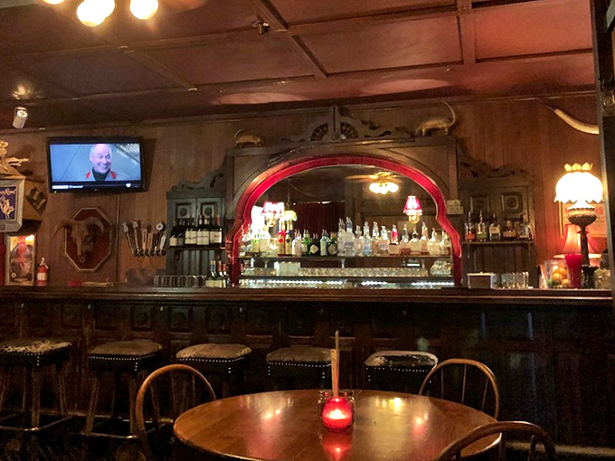 A bar that beckons with amber lighting and the promise of perfectly mixed drinks. That red glow isn't just ambiance—it's an invitation.