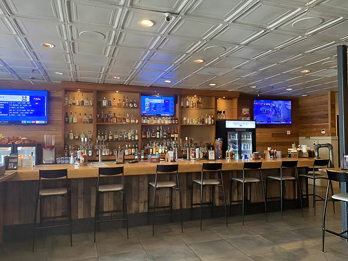 The bar's impressive bourbon collection stands at attention like soldiers ready to defend you against sobriety after consuming half your weight in brisket.