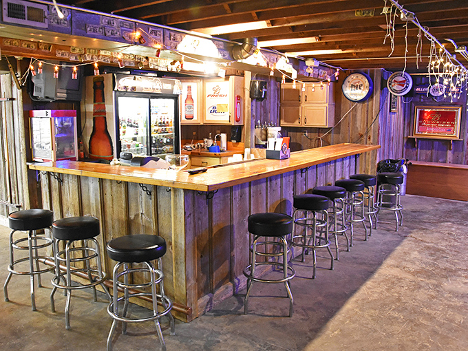 The rustic basement bar area feels like the coolest friend's garage—if that friend happened to serve perfect drinks and had great taste in neon signs.