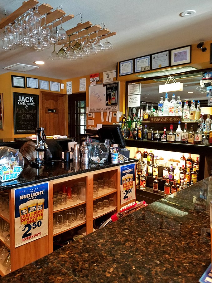 Bottles standing at attention like soldiers guarding liquid happiness. The overhead glasses await their moment to serve.
