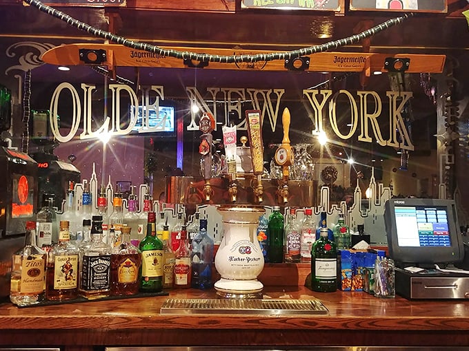 The bar's mirrored backdrop reflects more than bottles – it captures decades of toasts, celebrations, and the occasional drowning of sorrows in excellent beer.