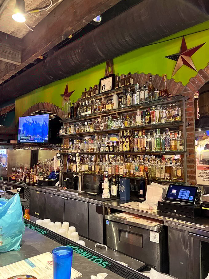 Bottles upon bottles of premium spirits line the wall like soldiers ready for duty. This bar means serious business behind all the fun.