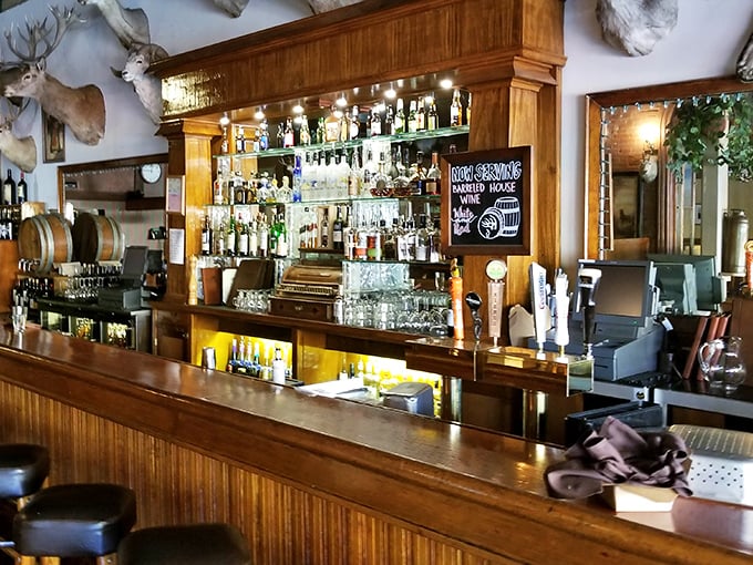 A bar that understands priorities – well-stocked shelves, polished wood, and enough space to settle in for serious conversations about life, love, and whether to order another round.