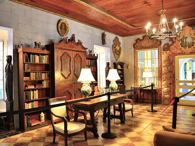 The library's rich wood furnishings and checkerboard floor create the perfect setting for contemplating great literature or planning your next garden party.