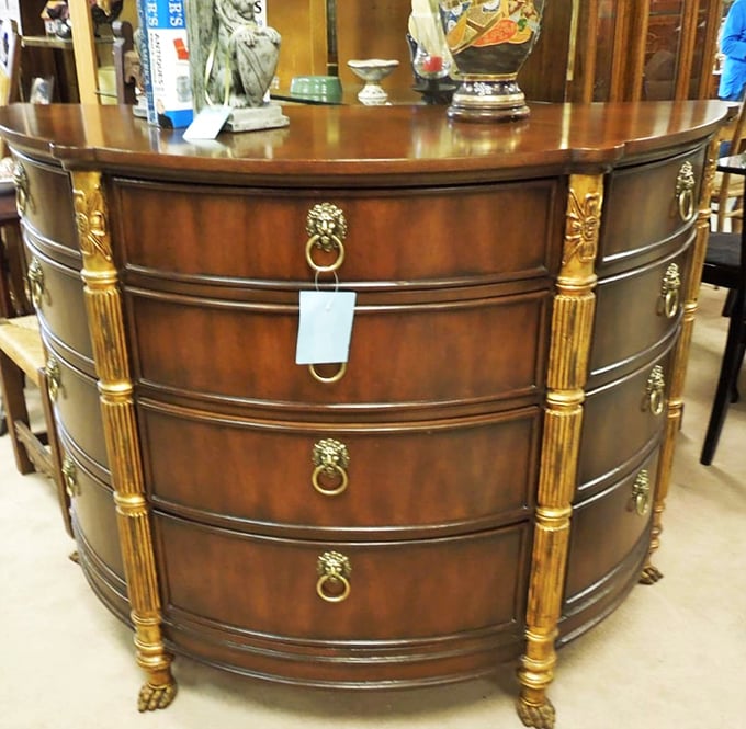 This bow-front dresser with lion-head pulls isn't just furniture—it's aristocracy for your bedroom at commoner prices.