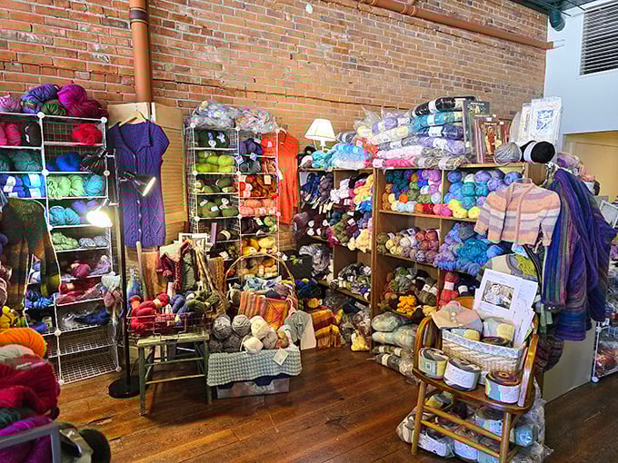 The Stitching Parlor explodes with color against exposed brick walls—a crafter's paradise where yarn becomes art and shopping becomes an adventure.
