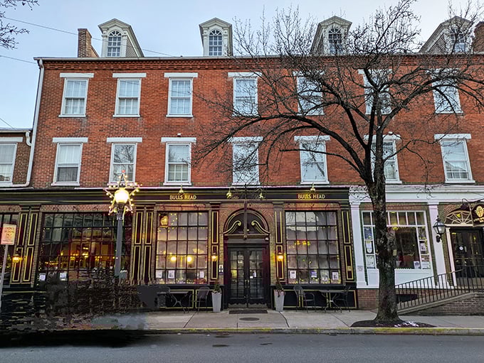 Bulls Head Public House glows invitingly at dusk, beckoning weary travelers to rest and refuel in historic surroundings.
