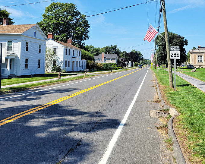 Classic New England homes line Route 286, standing tall like they've seen centuries of history and are politely waiting to see what happens next.