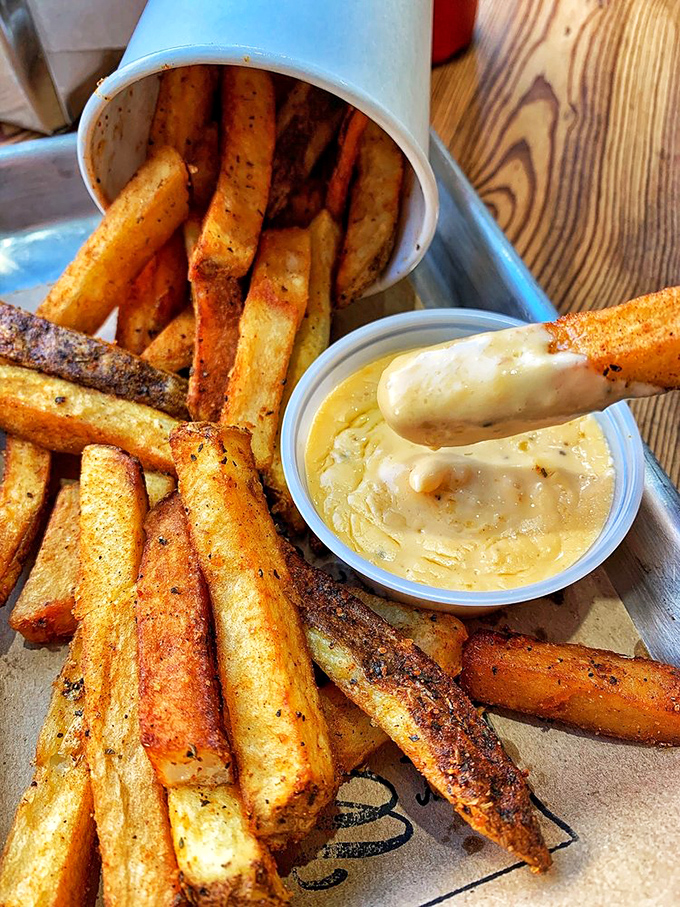 These aren't just fries—they're golden wands of potato perfection with a dipping sauce so good you'll contemplate drinking it straight.