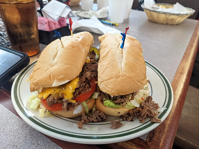 A sandwich so stuffed it needs structural support—those little flags aren't decoration, they're load-bearing architectural elements.
