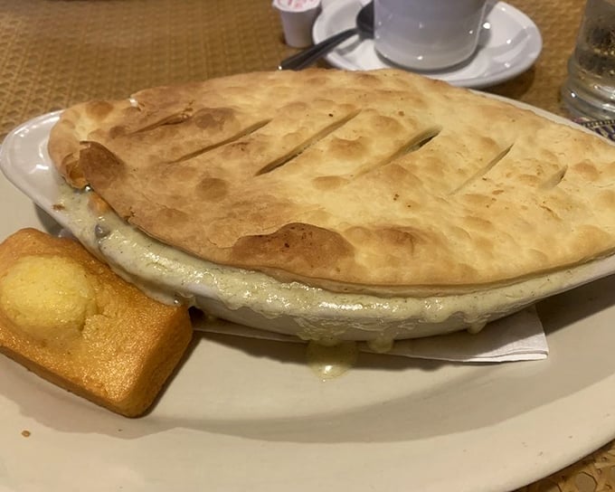 Not just a chicken pot pie—a fortress of flaky pastry protecting its precious cargo of comfort. Breaking that crust should require a permit.