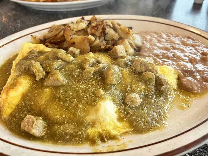 This chile verde omelet doesn't whisper its flavors—it belts them out in a three-part harmony of eggs, pork, and that vibrant green sauce that means business.