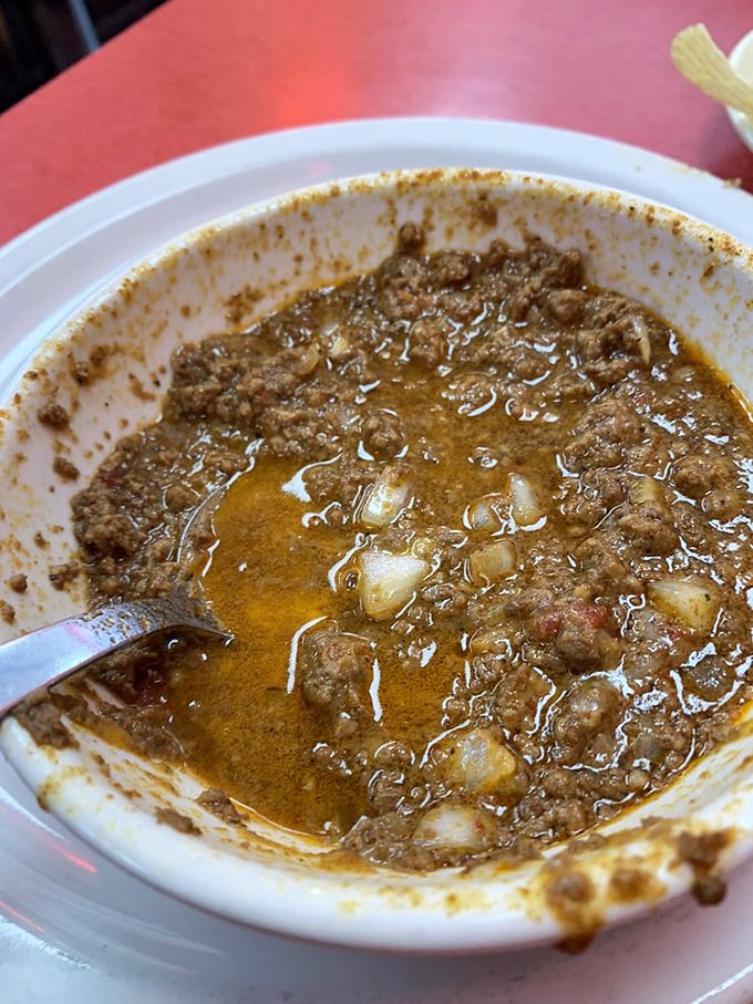 This isn't just chili—it's a bowl of liquid comfort that's been simmering its way to perfection. Spoons were invented for moments like this.
